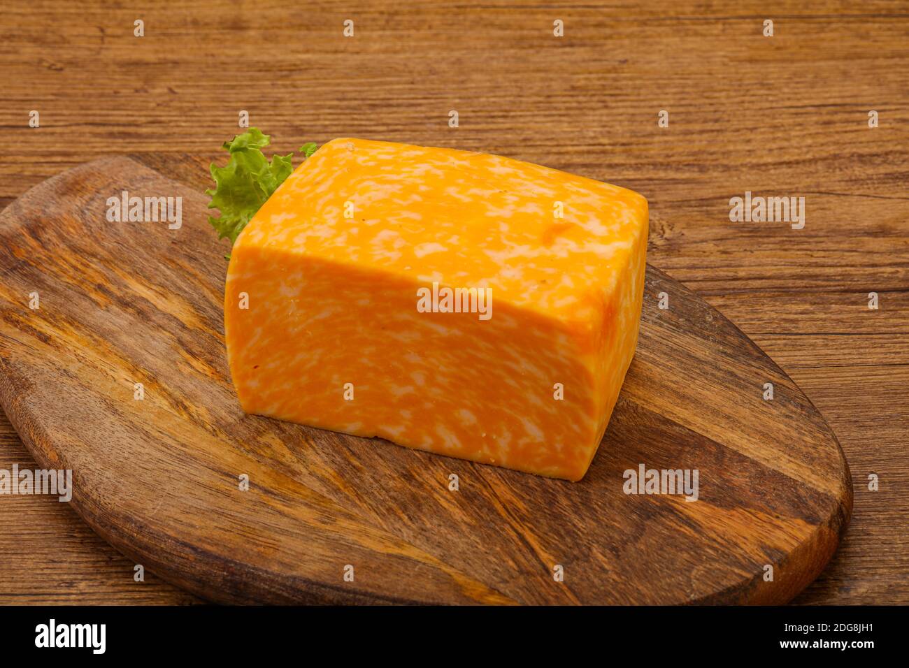 Dairy Marble cheese brick over board Stock Photo - Alamy