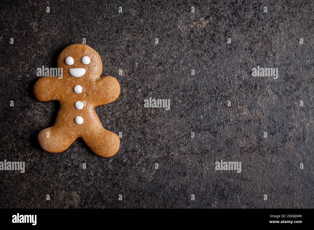 Xmas gingerbread man on black table. Top view Stock Photo - Alamy