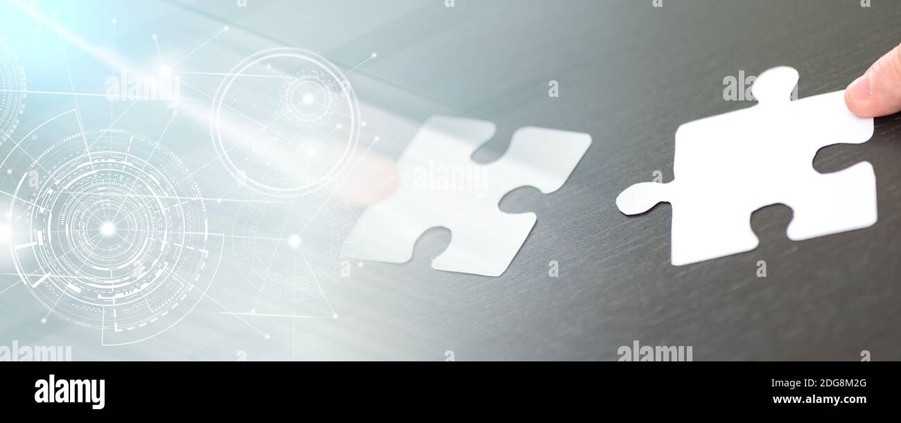 Hands joining two puzzle pieces, teamwork concept; panoramic banner ...
