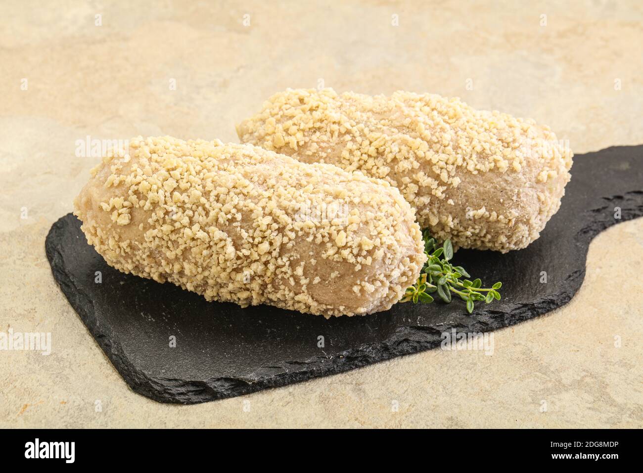 Raw breaded chicken cutlet for roast Stock Photo - Alamy