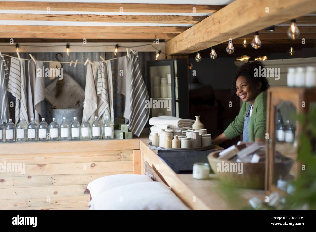 Happy female shop owner standing behind counter Stock Photo - Alamy