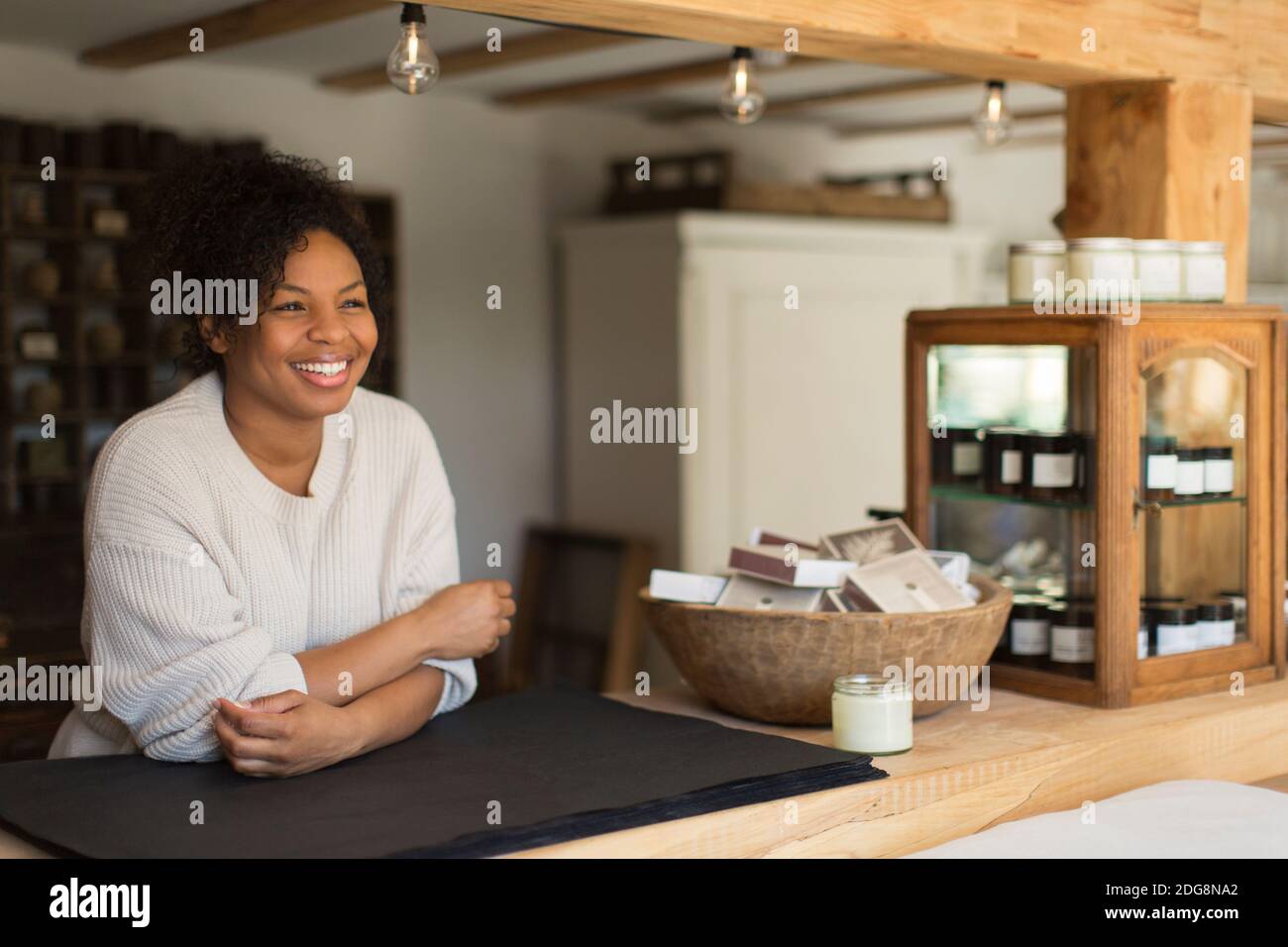 Portrait happy confident female shop owner at counter Stock Photo - Alamy
