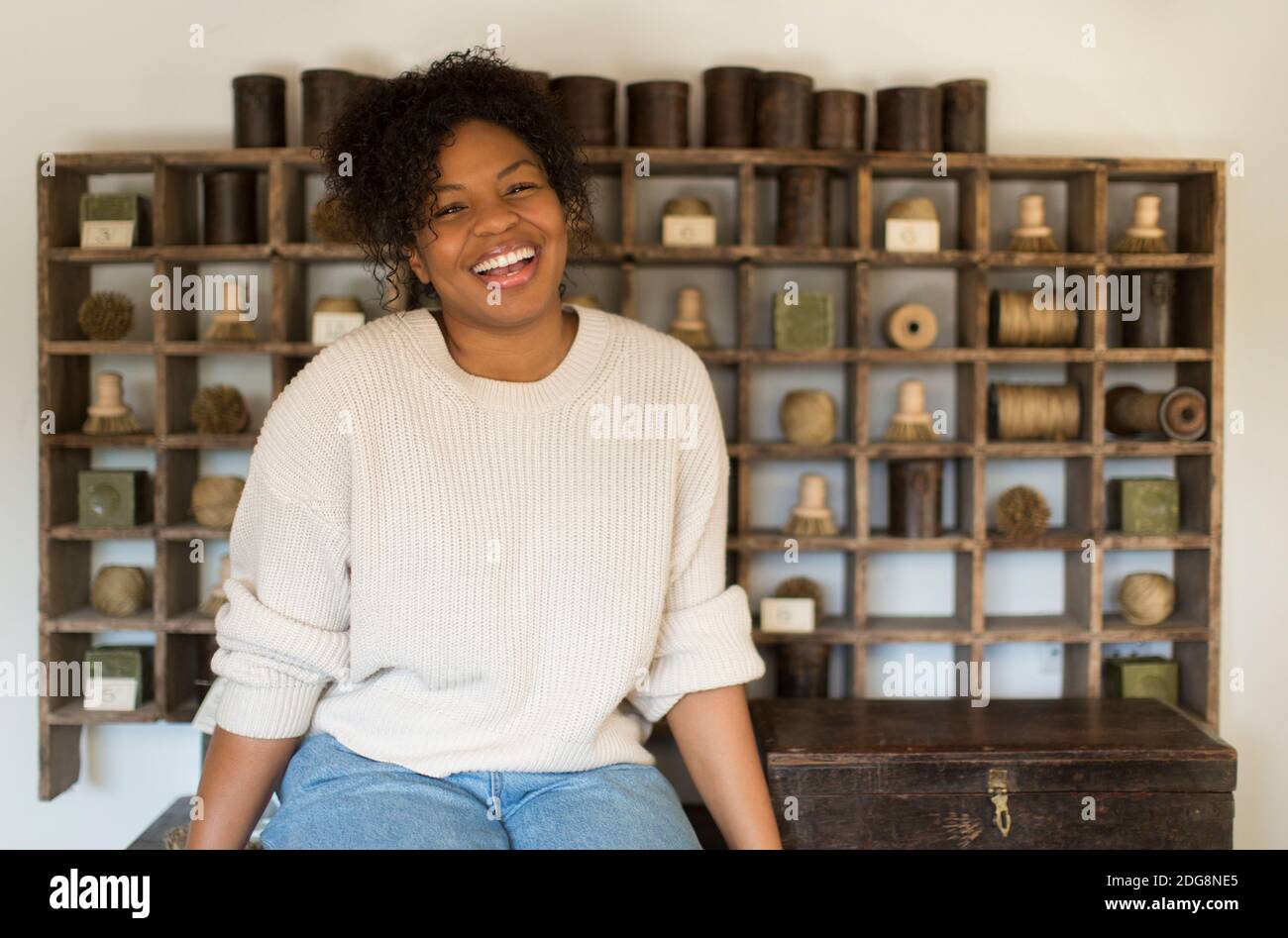 Portrait happy female shop owner at vintage display Stock Photo - Alamy