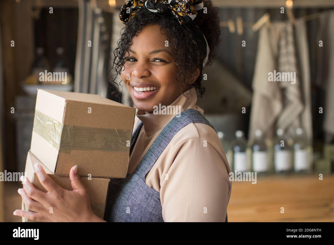 Portrait happy confident female shop owner with cardboard boxes Stock ...