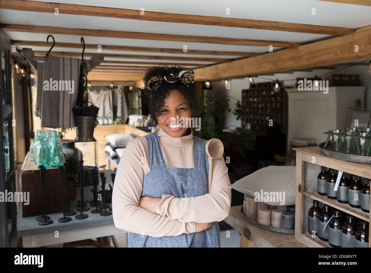 Portrait happy female shop owner with wooden spoon Stock Photo - Alamy