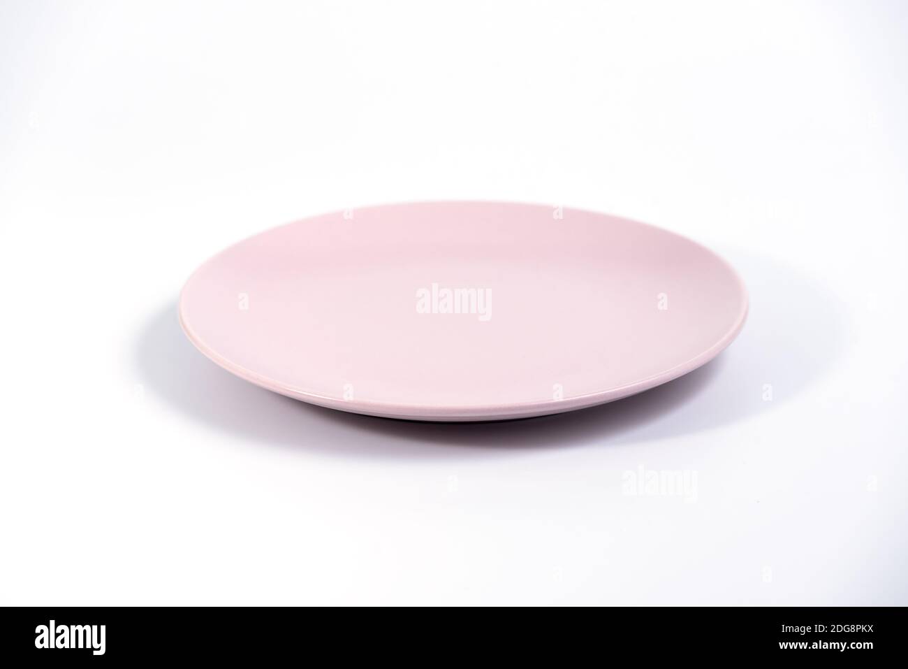 Empty Pink plate isolated on white background side view, selective ...