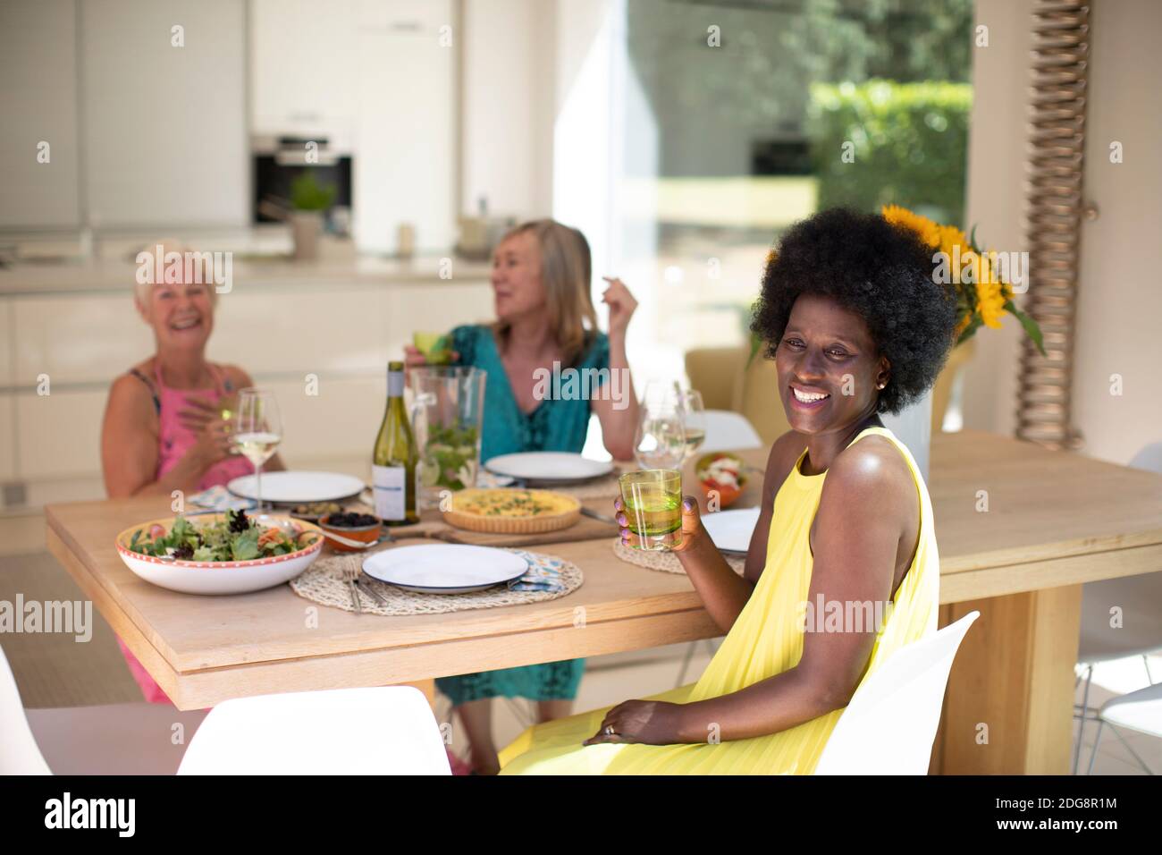 Portrait happy senior women friends enjoying luncheon in dining room ...