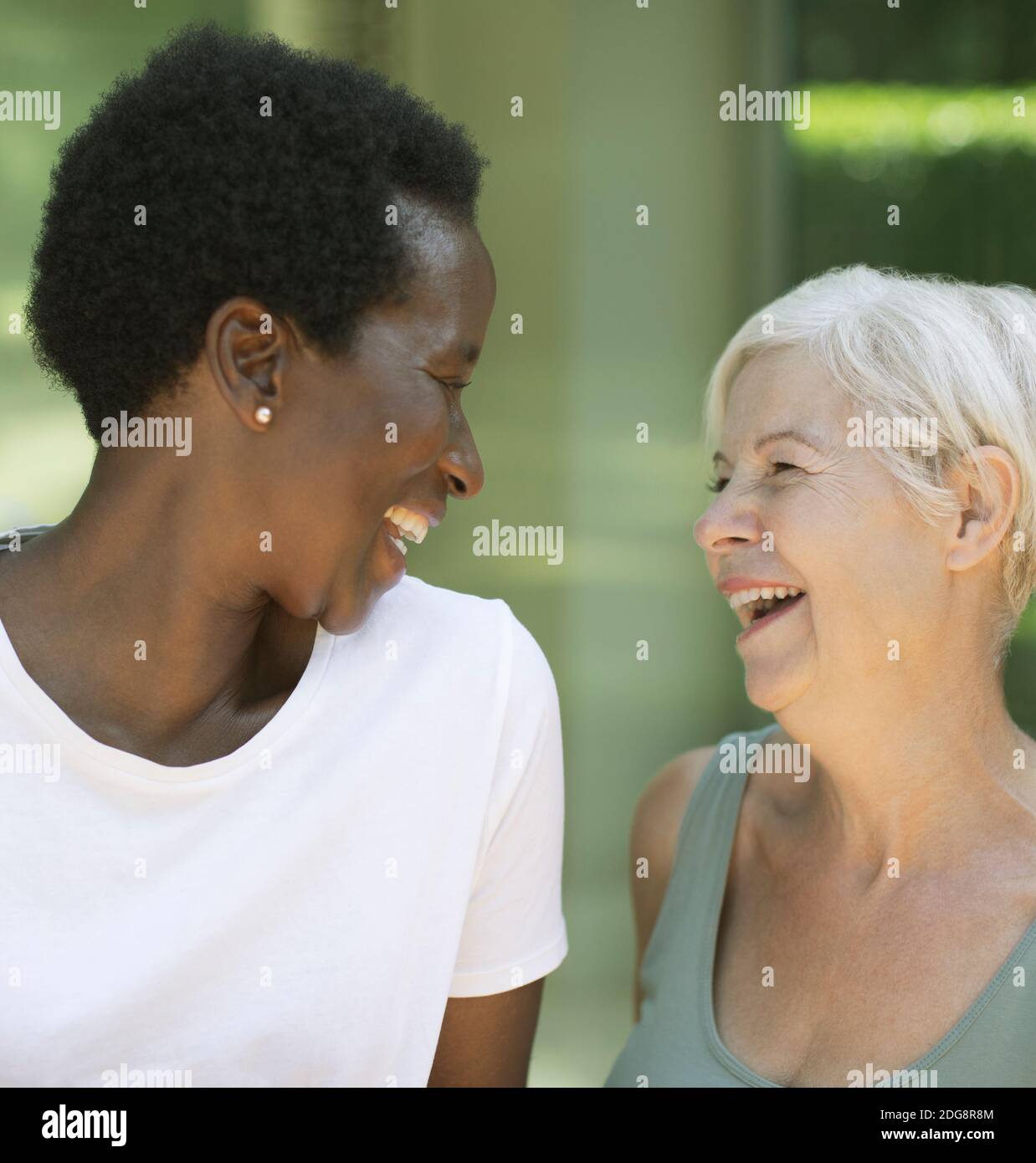 Happy senior women friends laughing Stock Photo - Alamy