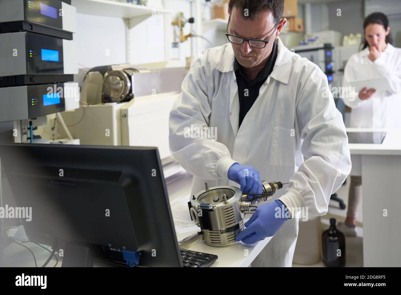 Scientist using laboratory equipment in hi-res stock photography and ...