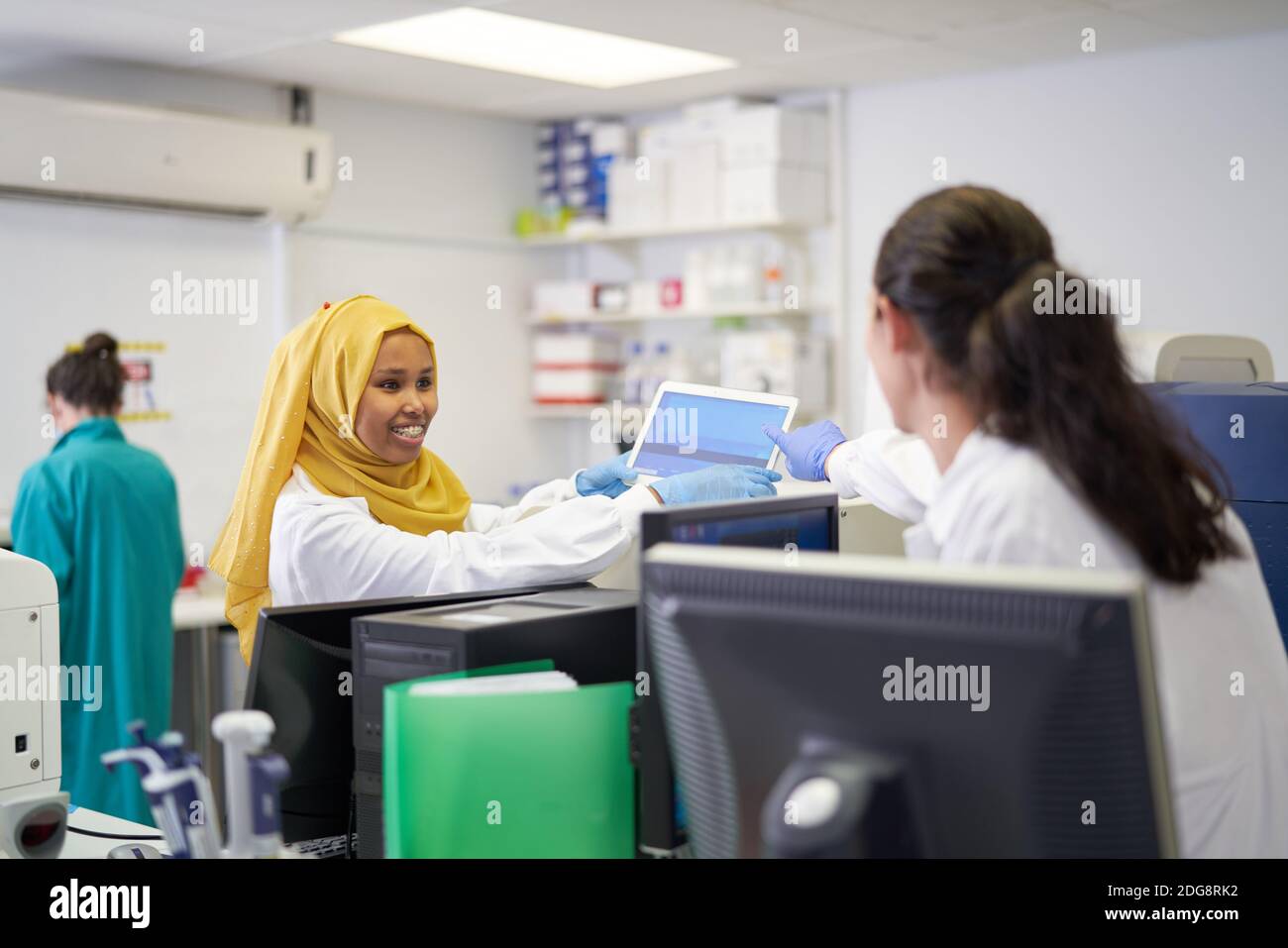 Female scientists using laptop in laboratory Stock Photo - Alamy