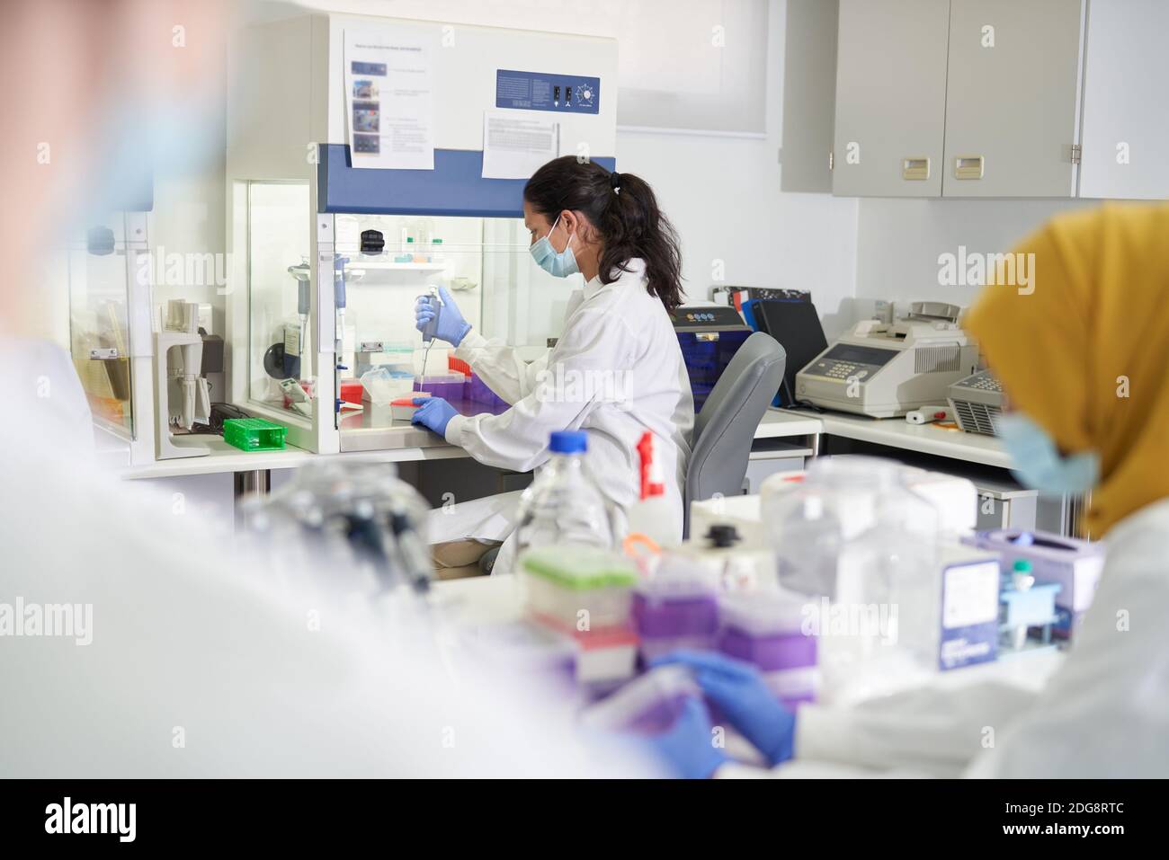 Female scientist in face mask and gloves working in laboratory Stock ...
