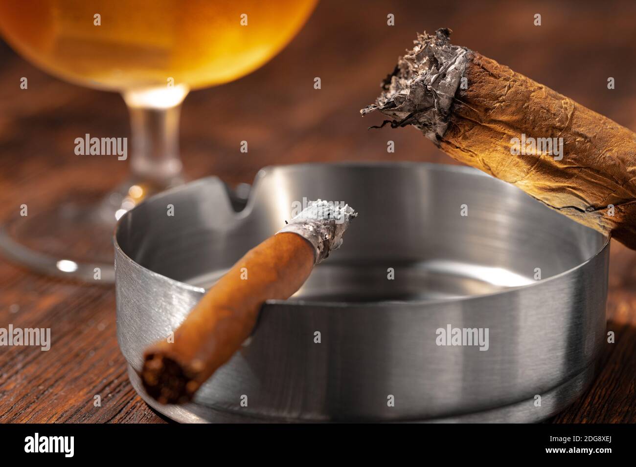 Glass of whisky and lighted cigar in an ash tray Stock Photo - Alamy