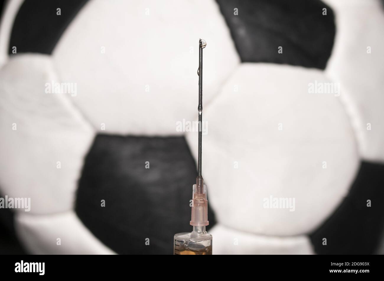 Before a soccer ball is an injection, doping in sports Stock Photo - Alamy