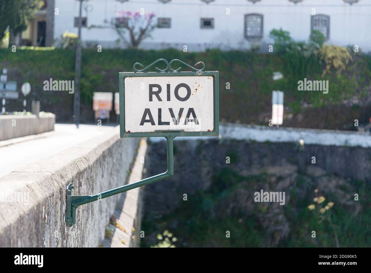 An old sign ''Rio Alva'' on a stone bridge in the historic town of ...