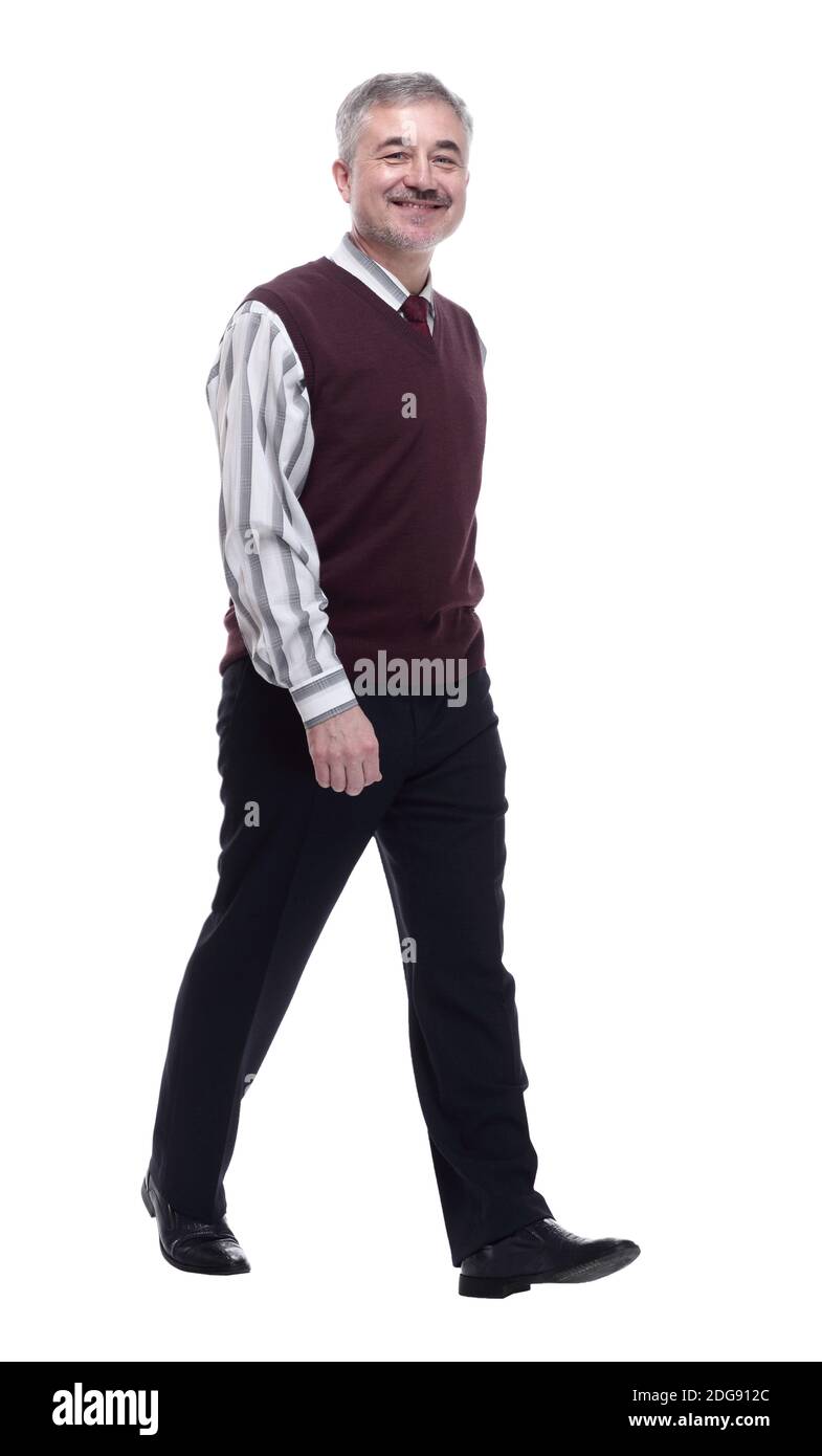 smiling mature man striding forward. isolated on a white Stock Photo ...