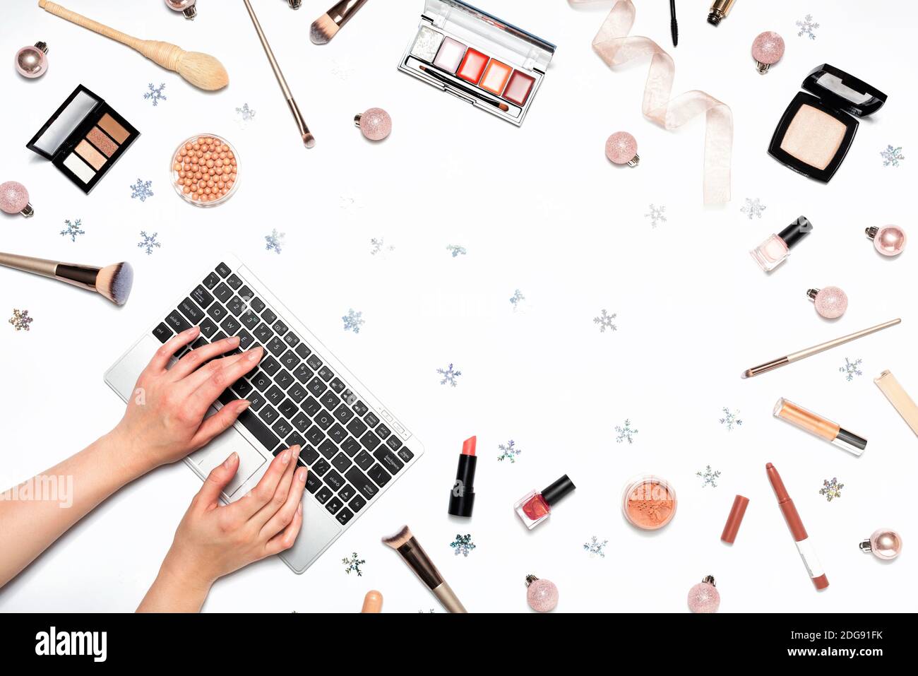 Female hands typing on laptop keyboard. Decorative cosmetics and makeup ...