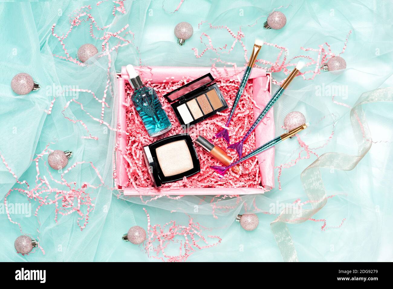 Beauty box with makeup cosmetics filled with shredded pink paper ...