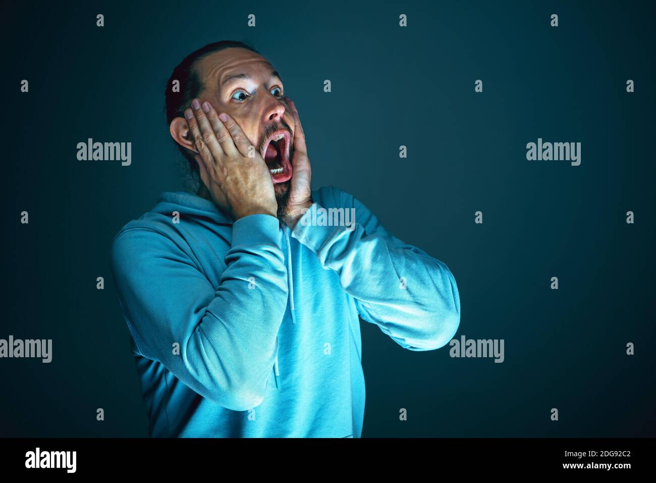 Spooky. Portrait of young crazy scared and shocked caucasian man ...