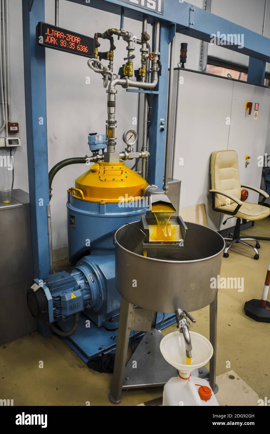A vertical shot of the olive oil extraction process through modern ...