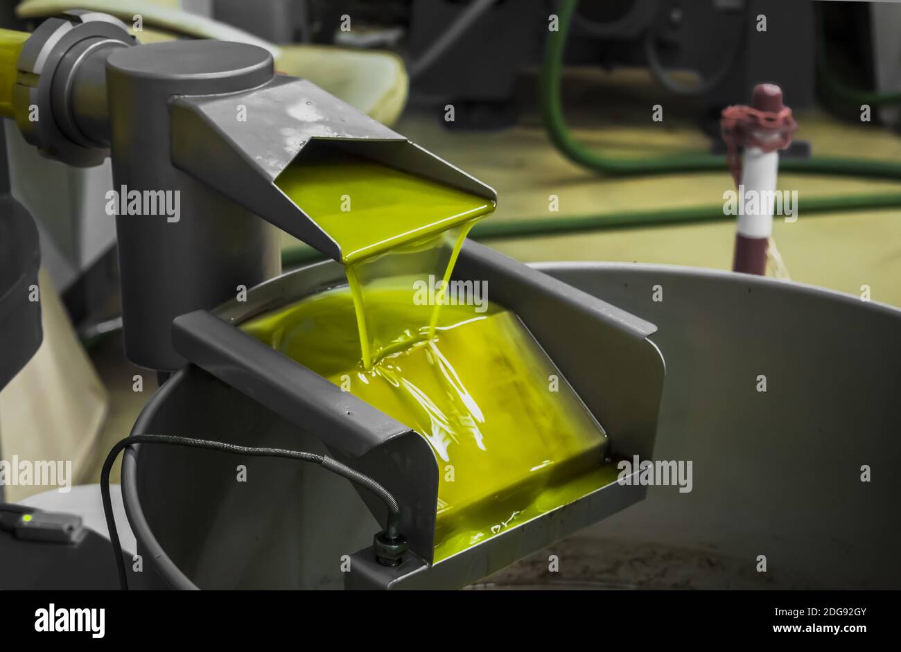 A closeup shot of an olive oil extraction process in a factory Stock ...