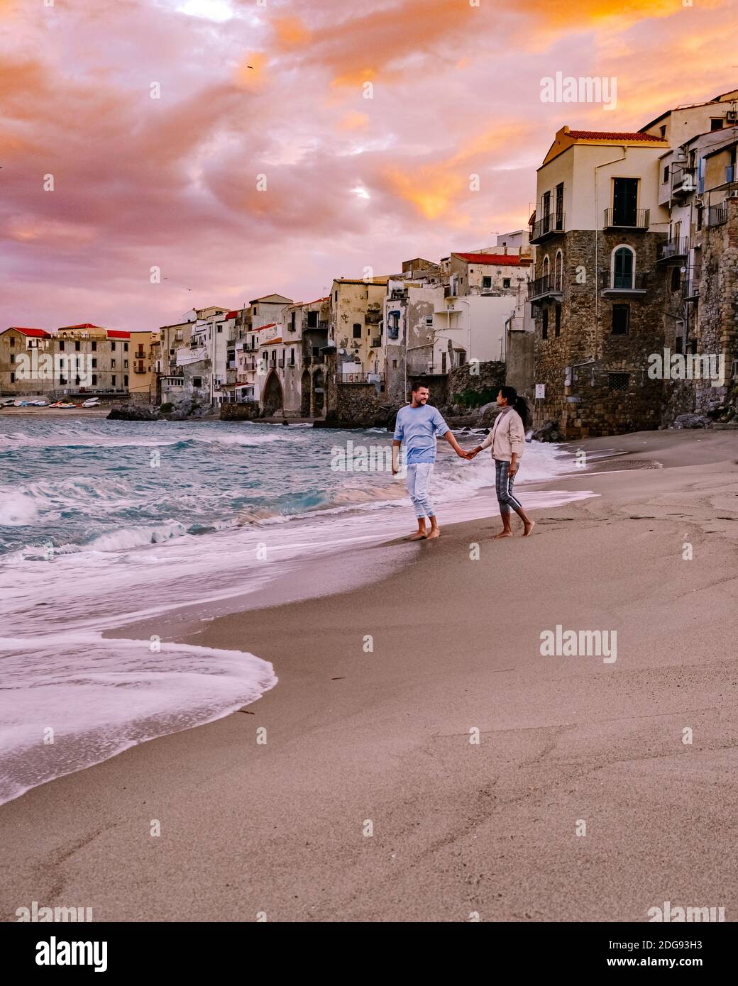 couple on vacation Sicily visiting the old town of Cefalu,sunset at the ...