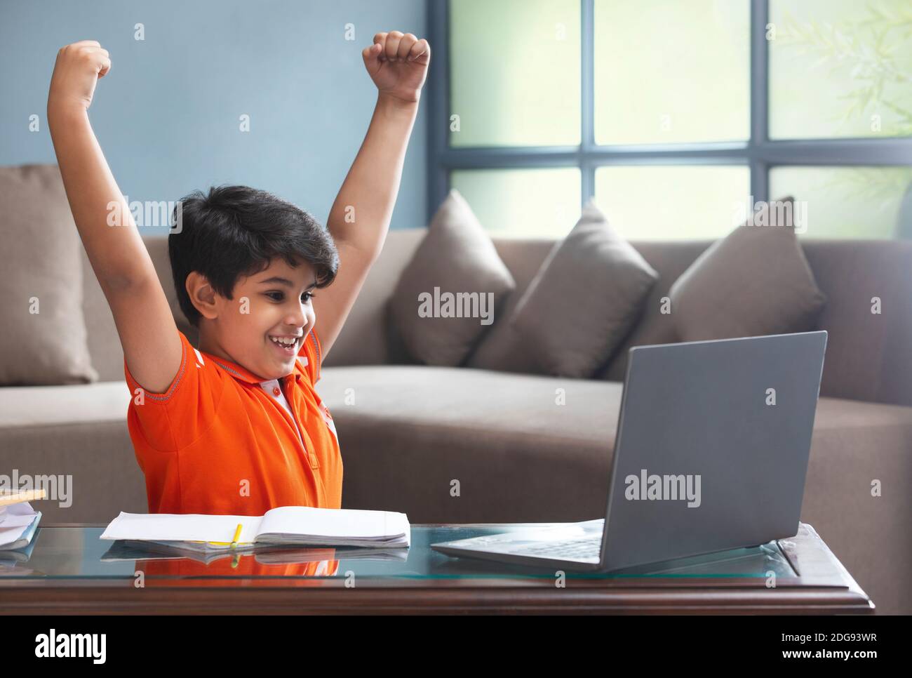 A YOUNG BOY ACTIVELY PARTICIPATING IN ONLINE CLASS Stock Photo - Alamy