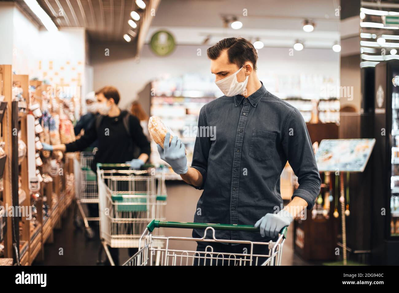 close up. young man buying bread in a supermarket Stock Photo - Alamy