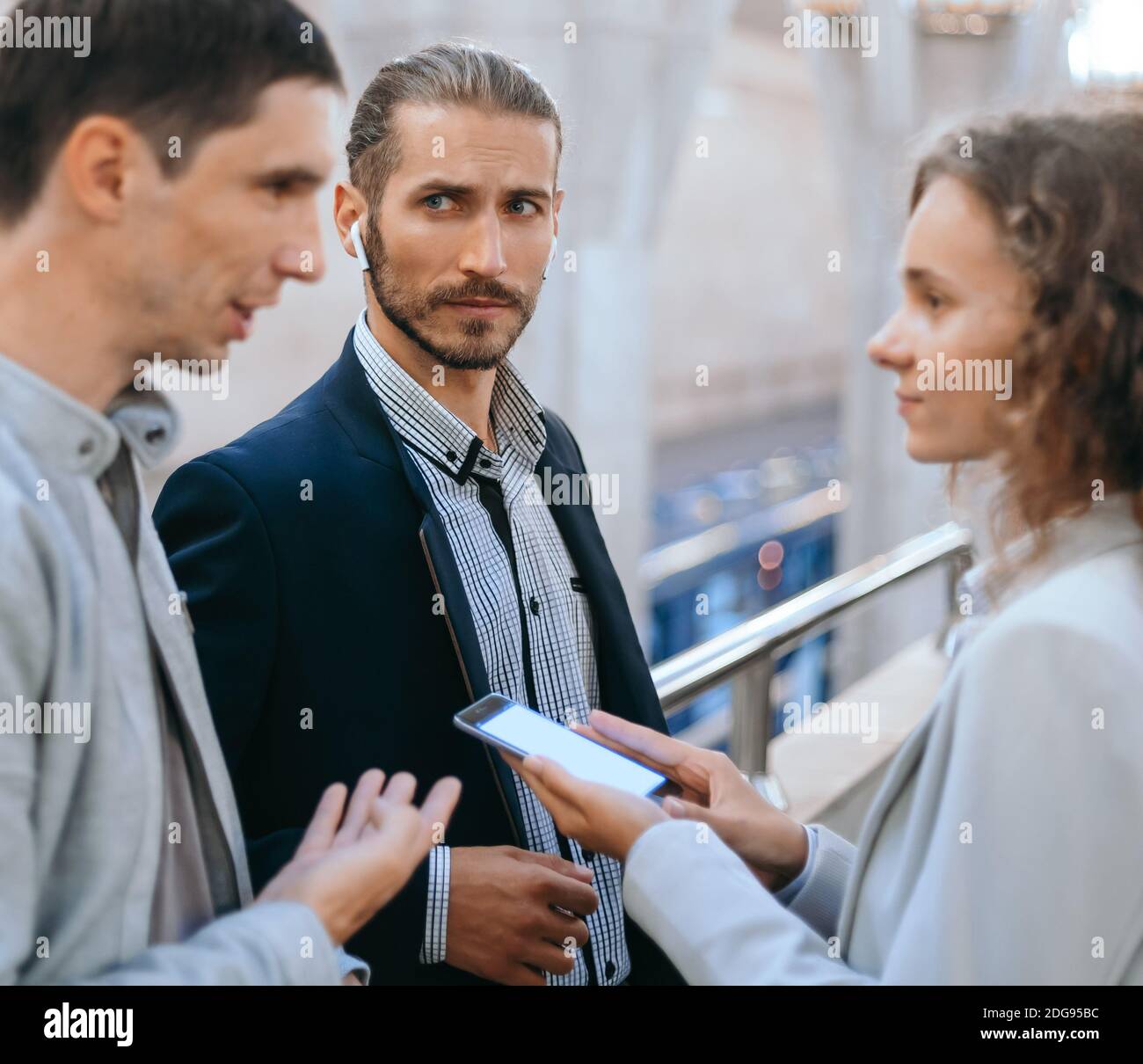 group of friends with a smartphone standing in the subway Stock Photo ...