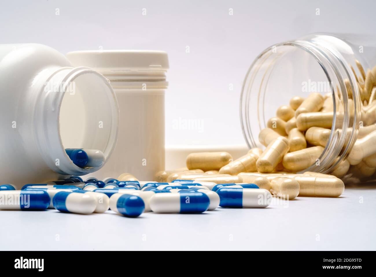Medications capsules in plastic bottles on light grey background Stock ...