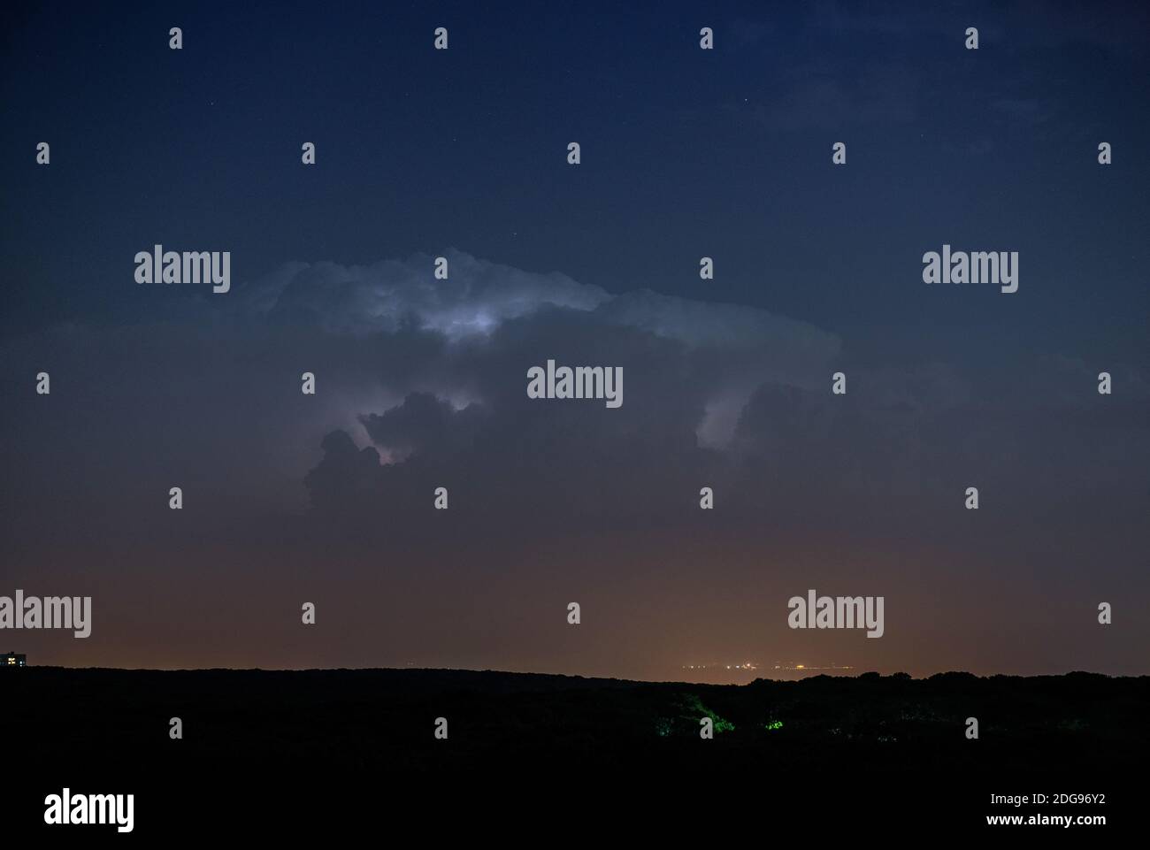 Thunderstorm clouds at night with lightning Stock Photo - Alamy
