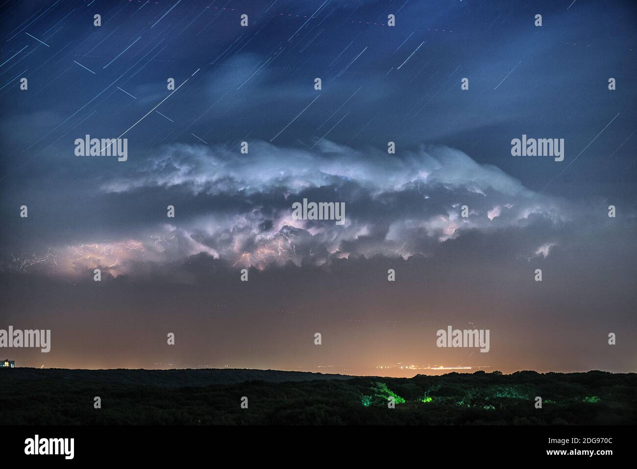 Thunderstorm clouds at night with lightning Stock Photo - Alamy