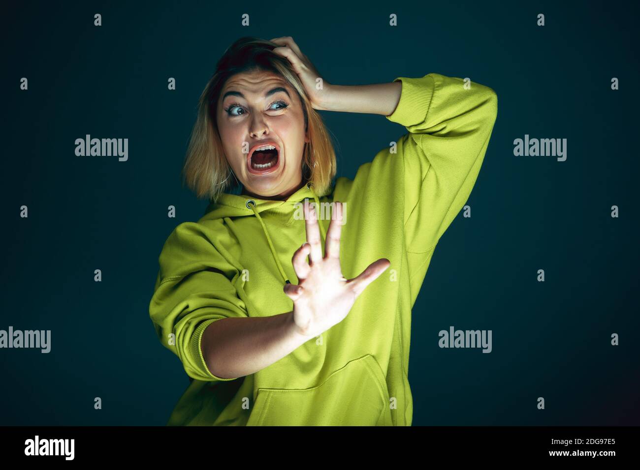 Screaming. Portrait of young crazy scared and shocked caucasian woman ...