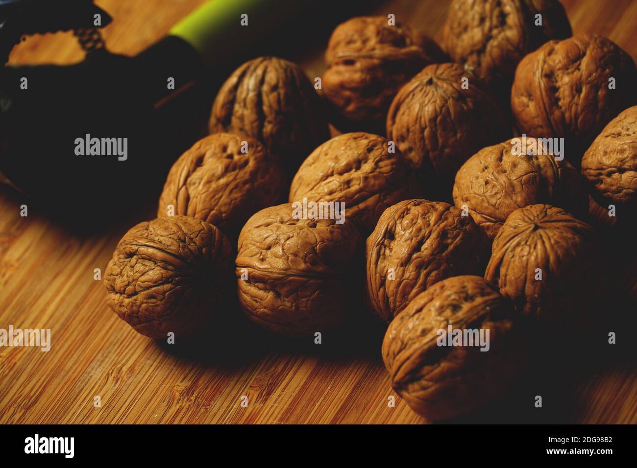 side view of walnuts with a matte color edition on bamboo wood ...
