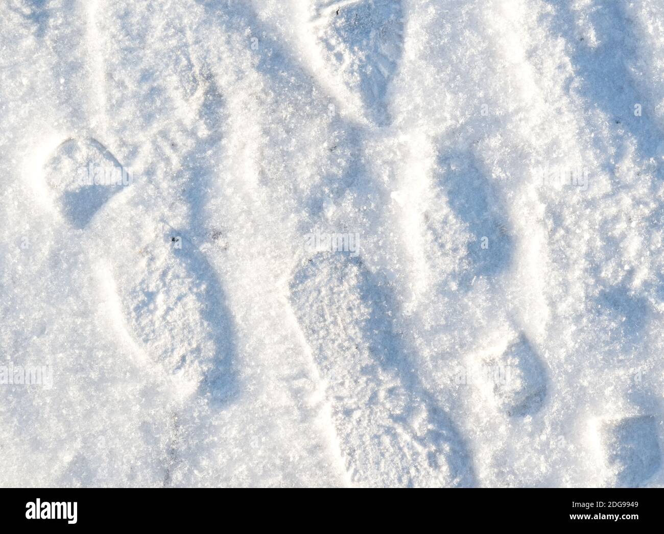 Footprints in the fresh snow Stock Photo - Alamy