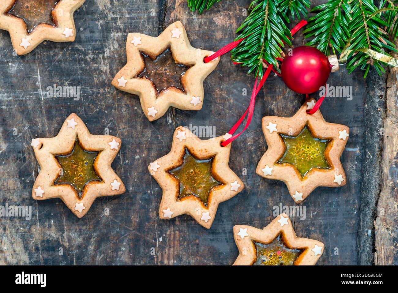 Star shaped stained glass window biscuits on wooden background ...