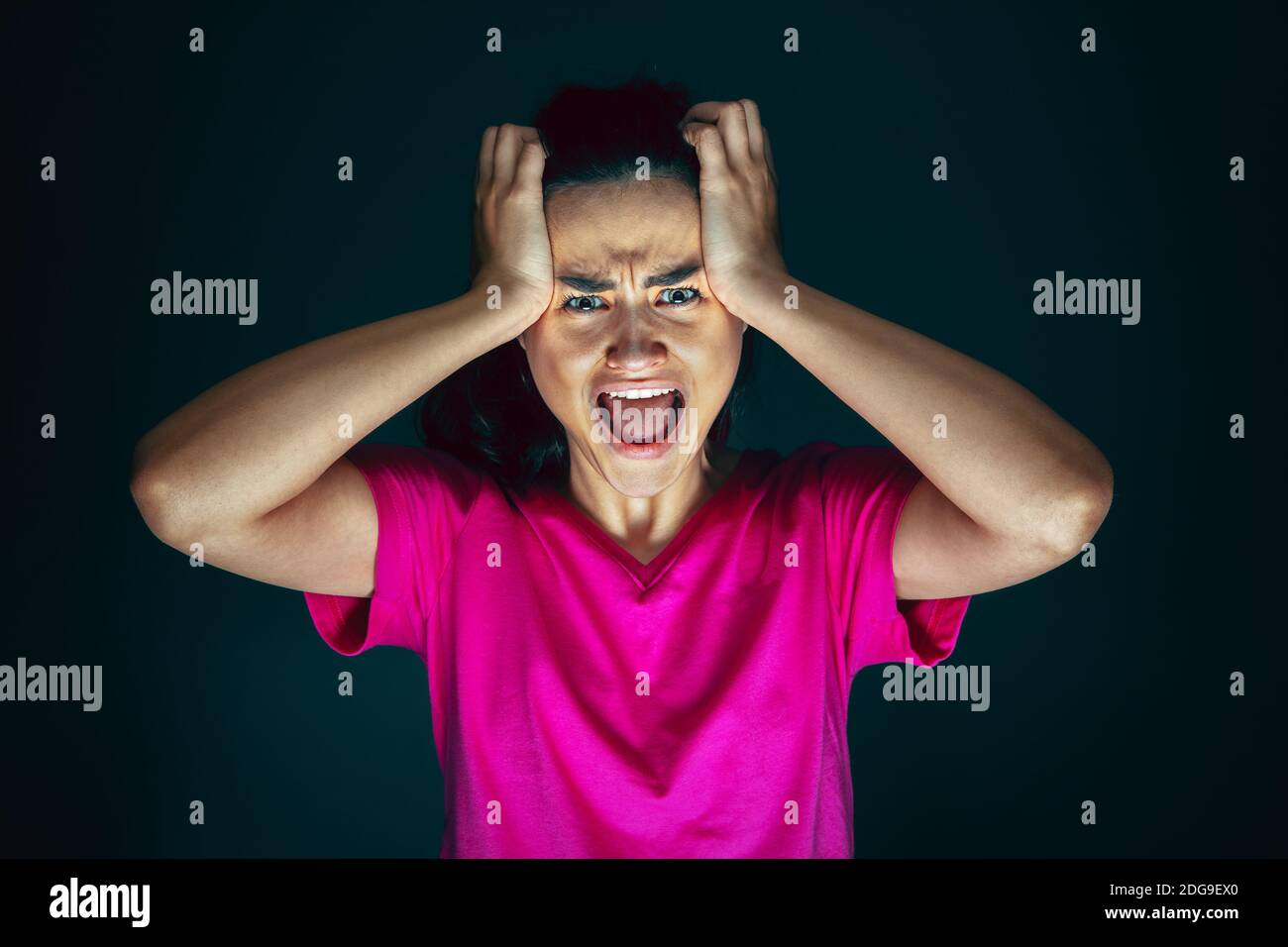 Screaming. Portrait of young crazy scared and shocked caucasian woman ...