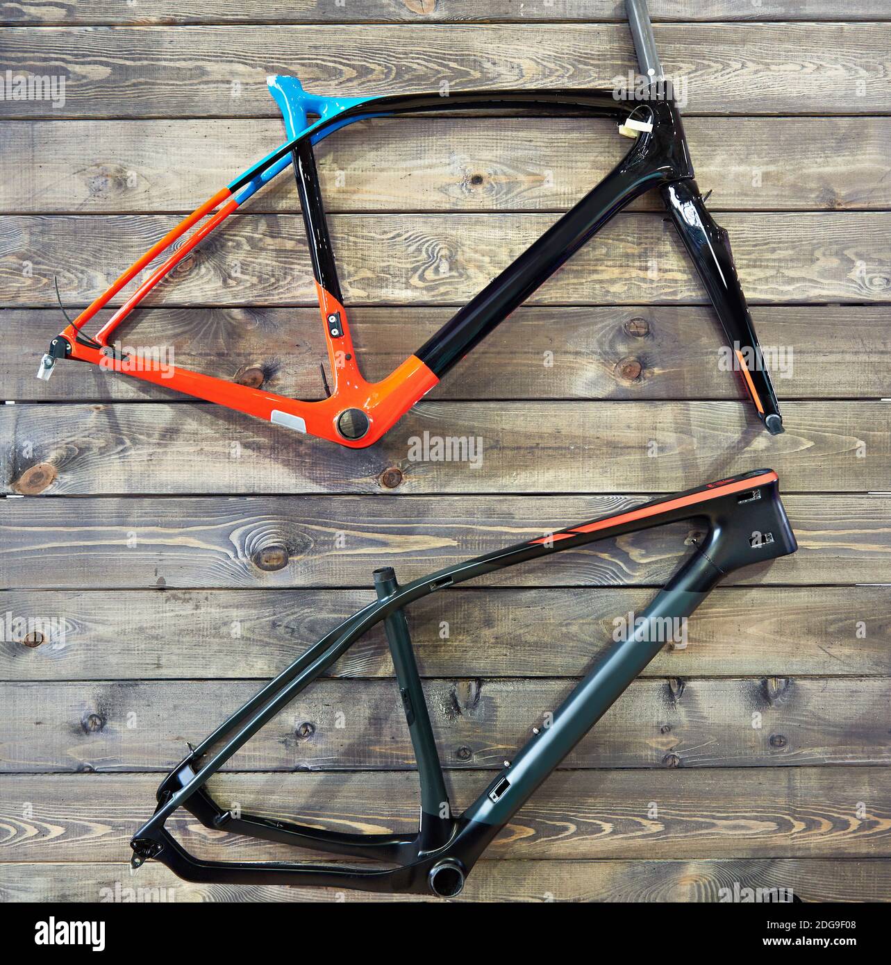 Bicycle frames on wooden wall in store Stock Photo - Alamy