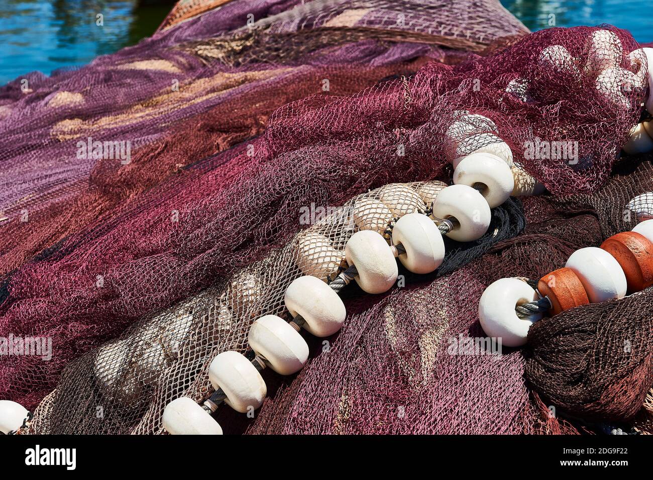 Pile of commercial fishing nets on a fishing quay Stock Photo - Alamy