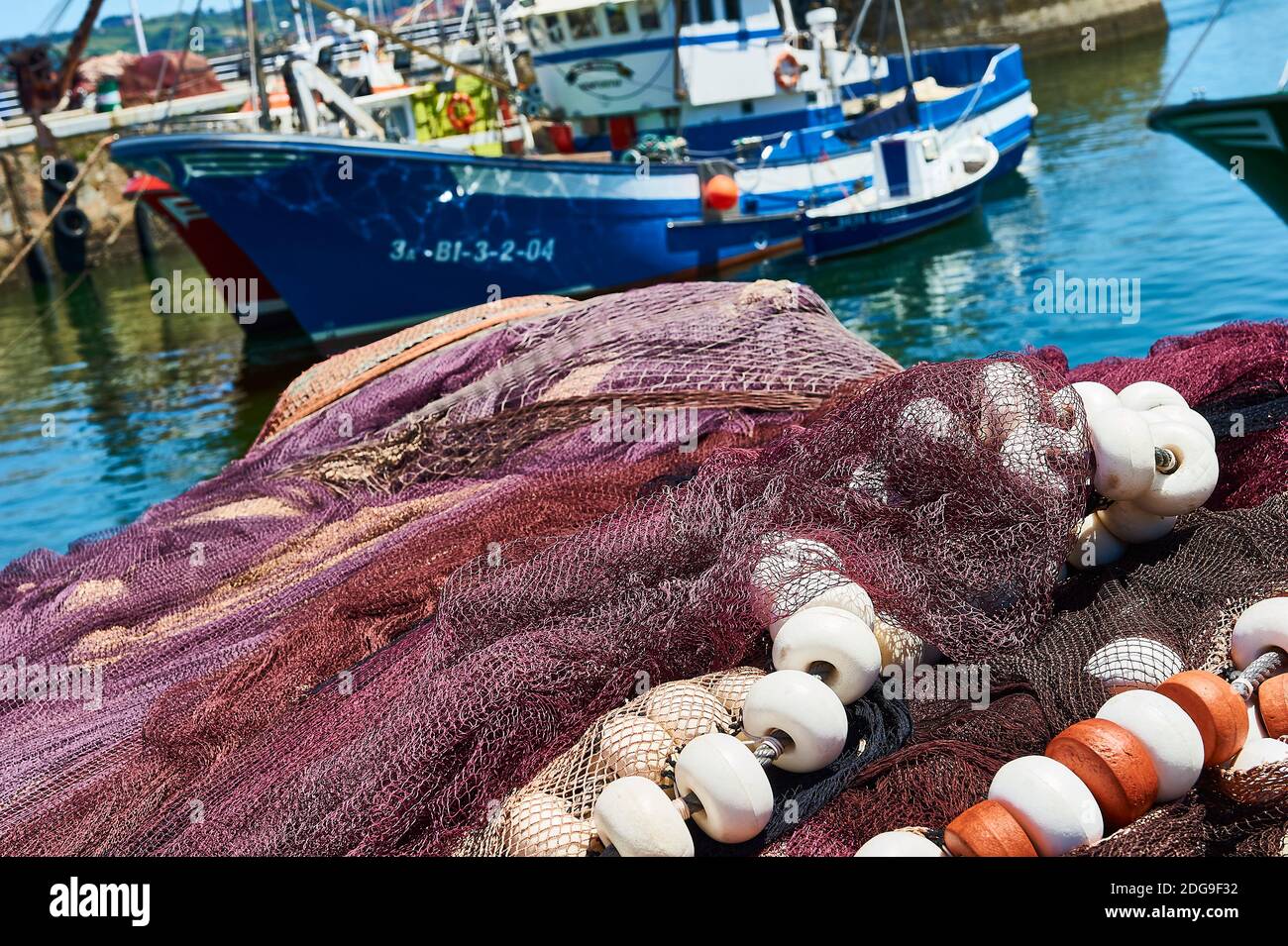 Pile of commercial fishing nets on a fishing quay Stock Photo - Alamy