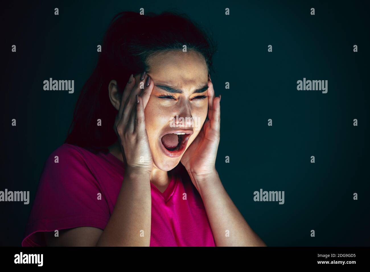 Screaming. Portrait of young crazy scared and shocked caucasian woman ...