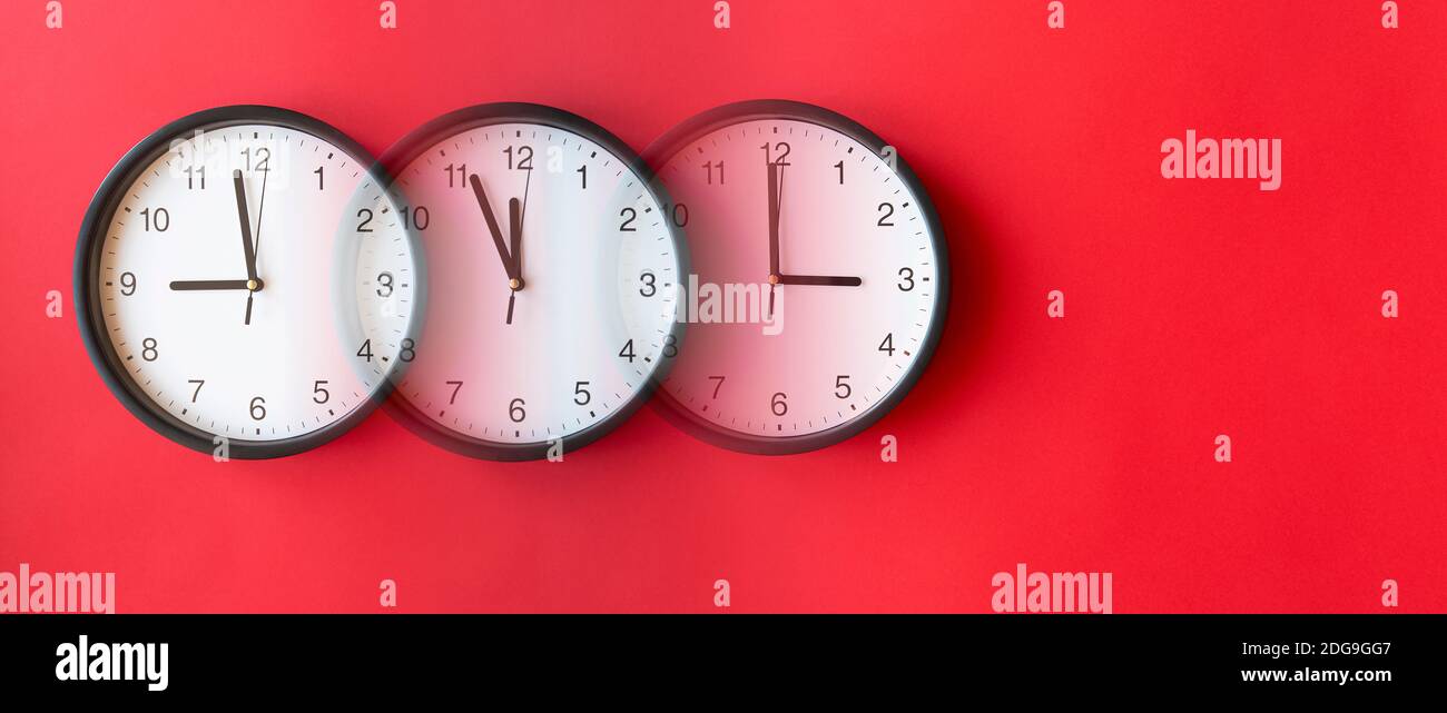 Round wall clocks on red surface showing 9, 12, 3, layout, top view ...