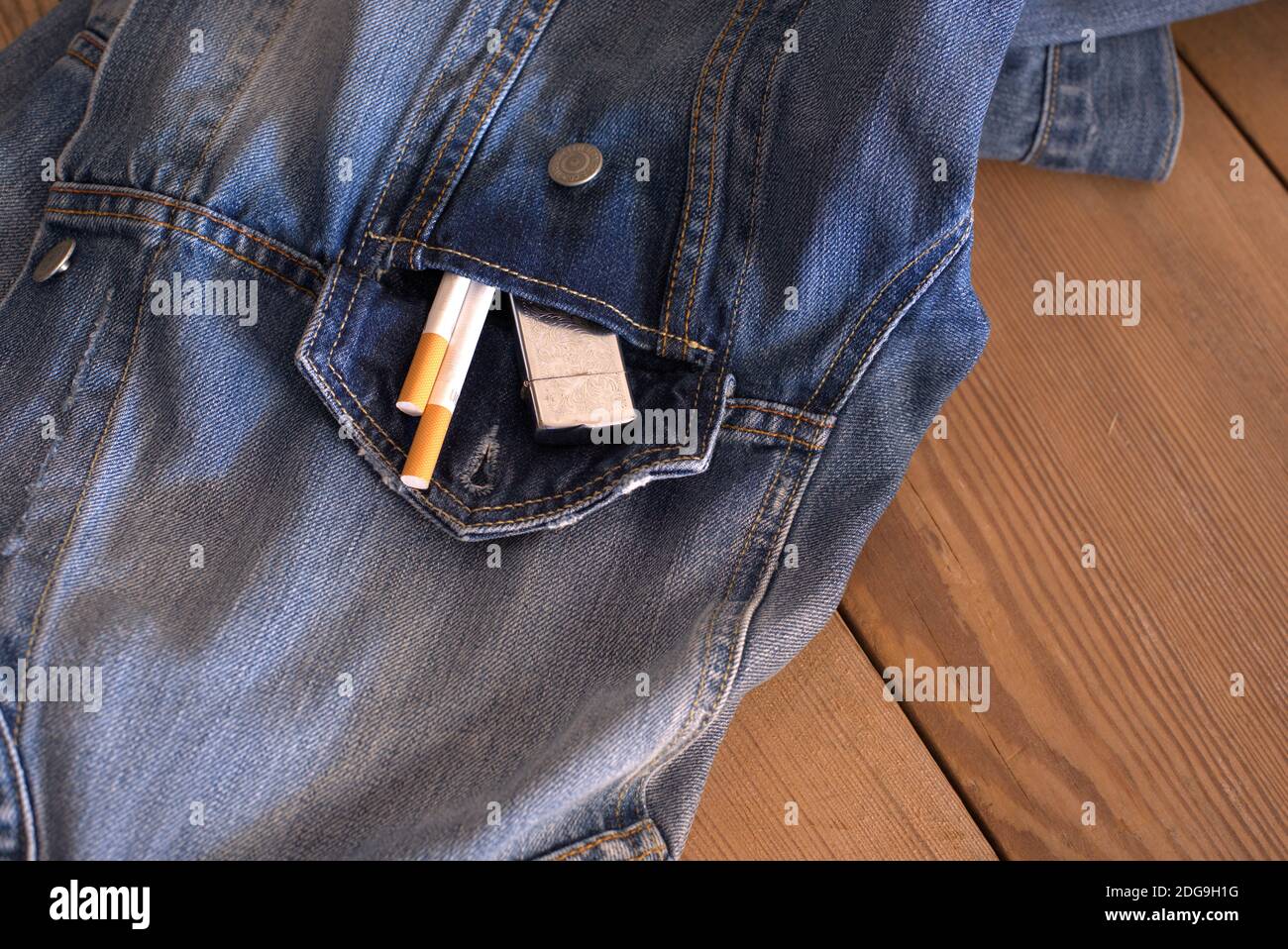 Tobacco cigarettes and metal lighter in a jeans jacket pocket Stock ...