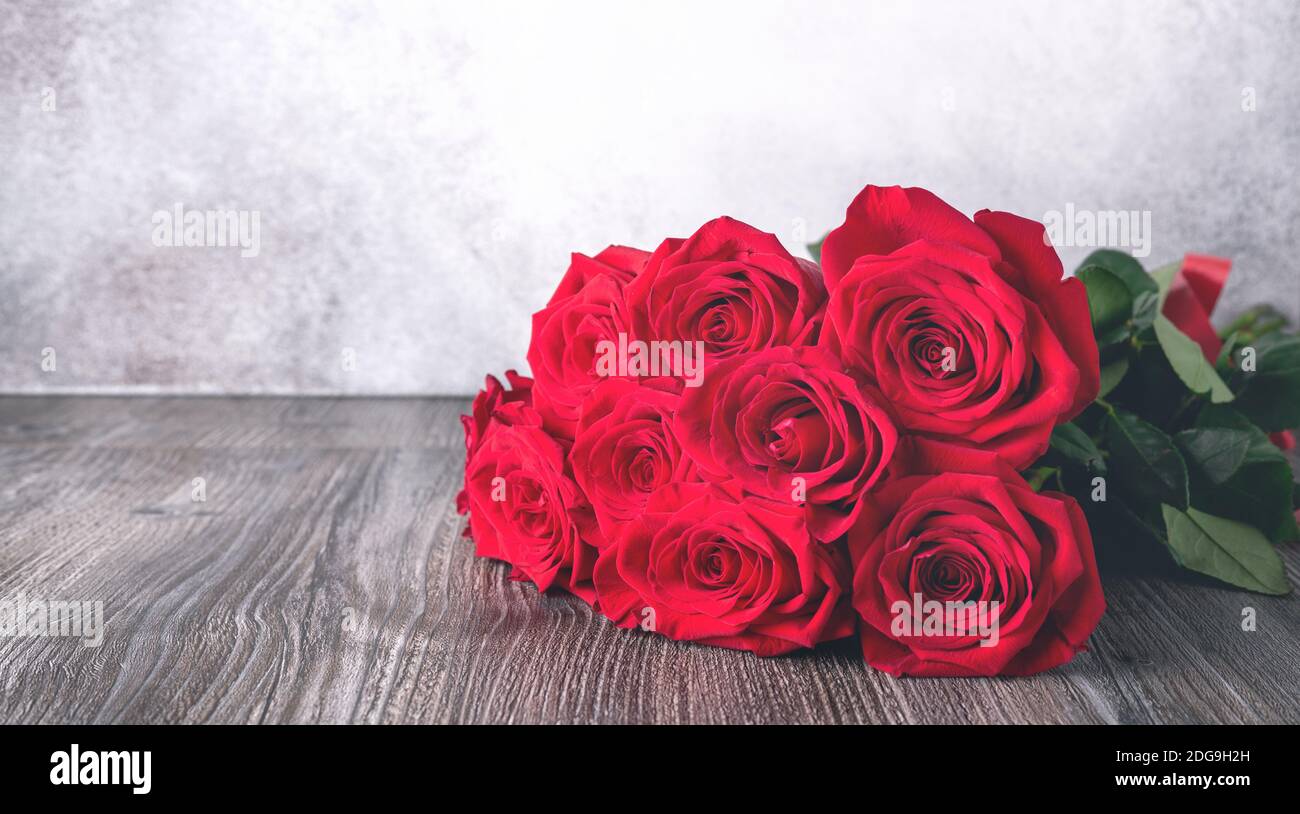 Red rose flowers bouquet on shelf in front of stone wall - Image Stock ...