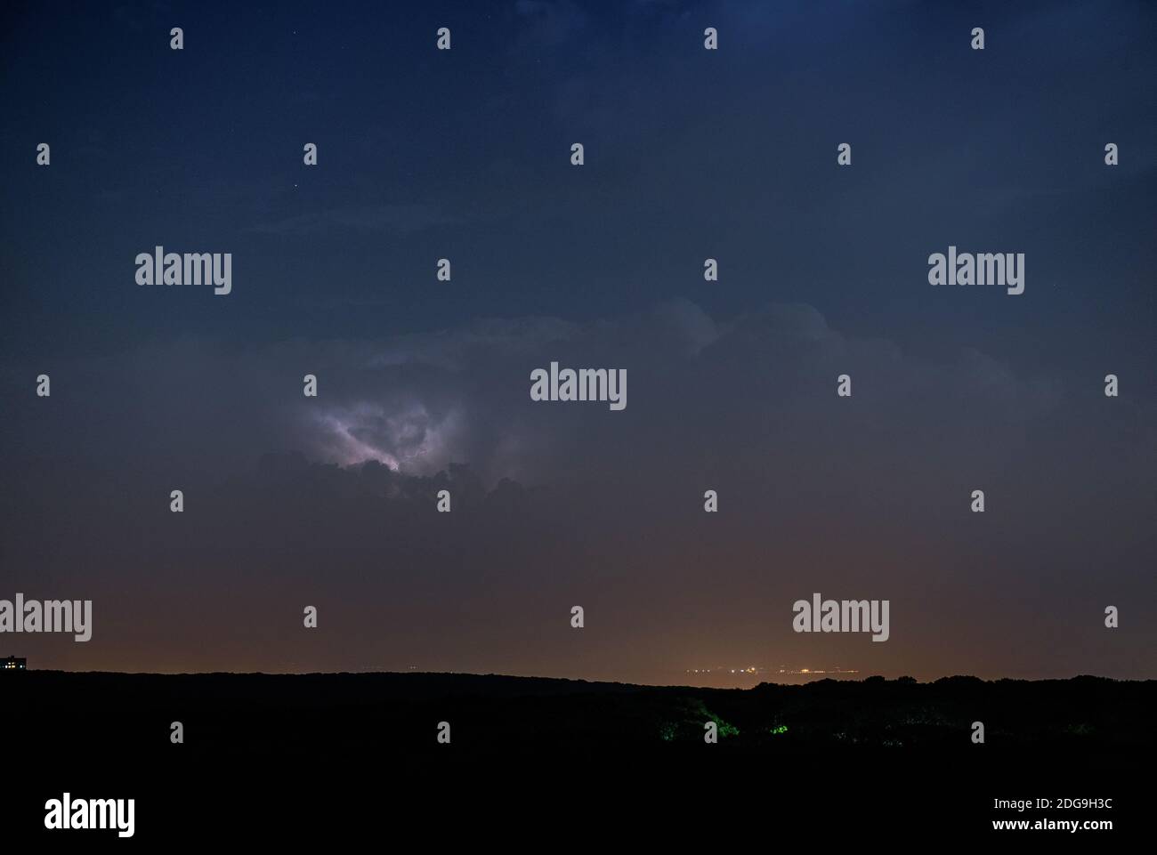 Thunderstorm clouds at night with lightning Stock Photo - Alamy