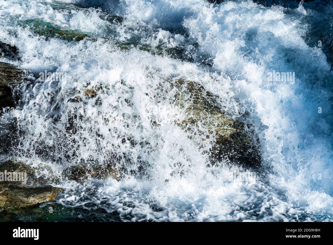 Wild and fast moving river rapids white water rushing over rugged ...