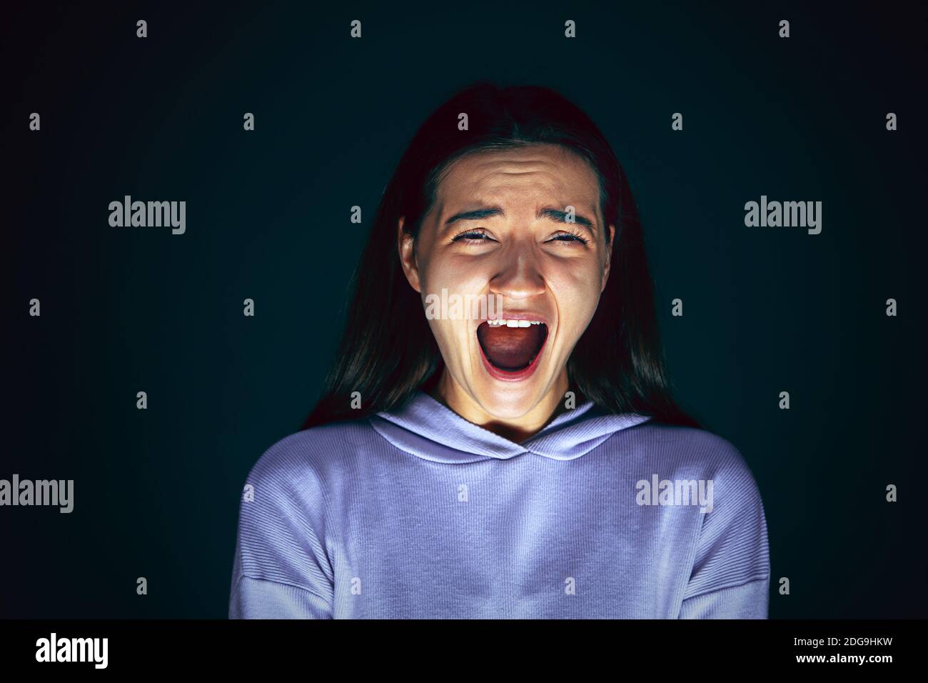 Screaming. Portrait of young crazy scared and shocked caucasian woman ...