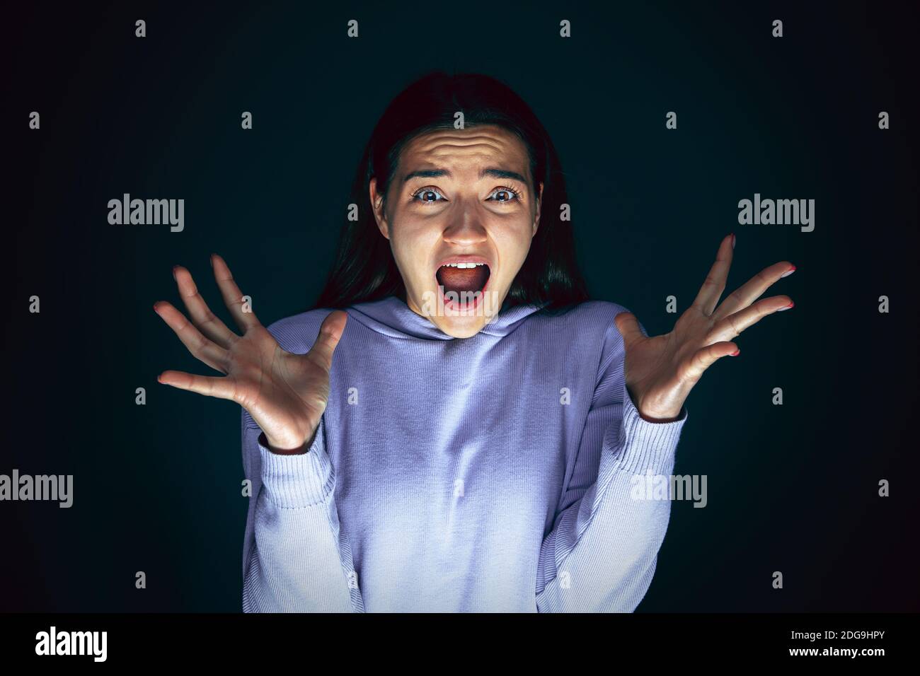 Screaming. Portrait of young crazy scared and shocked caucasian woman ...