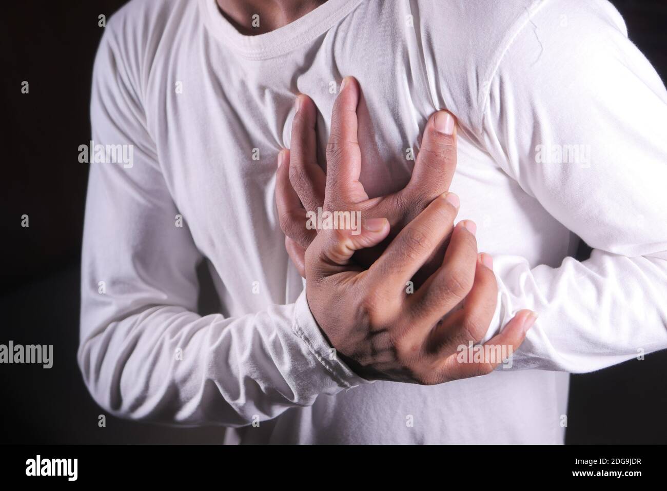 young man suffering pain in heart and holding chest with hand Stock ...