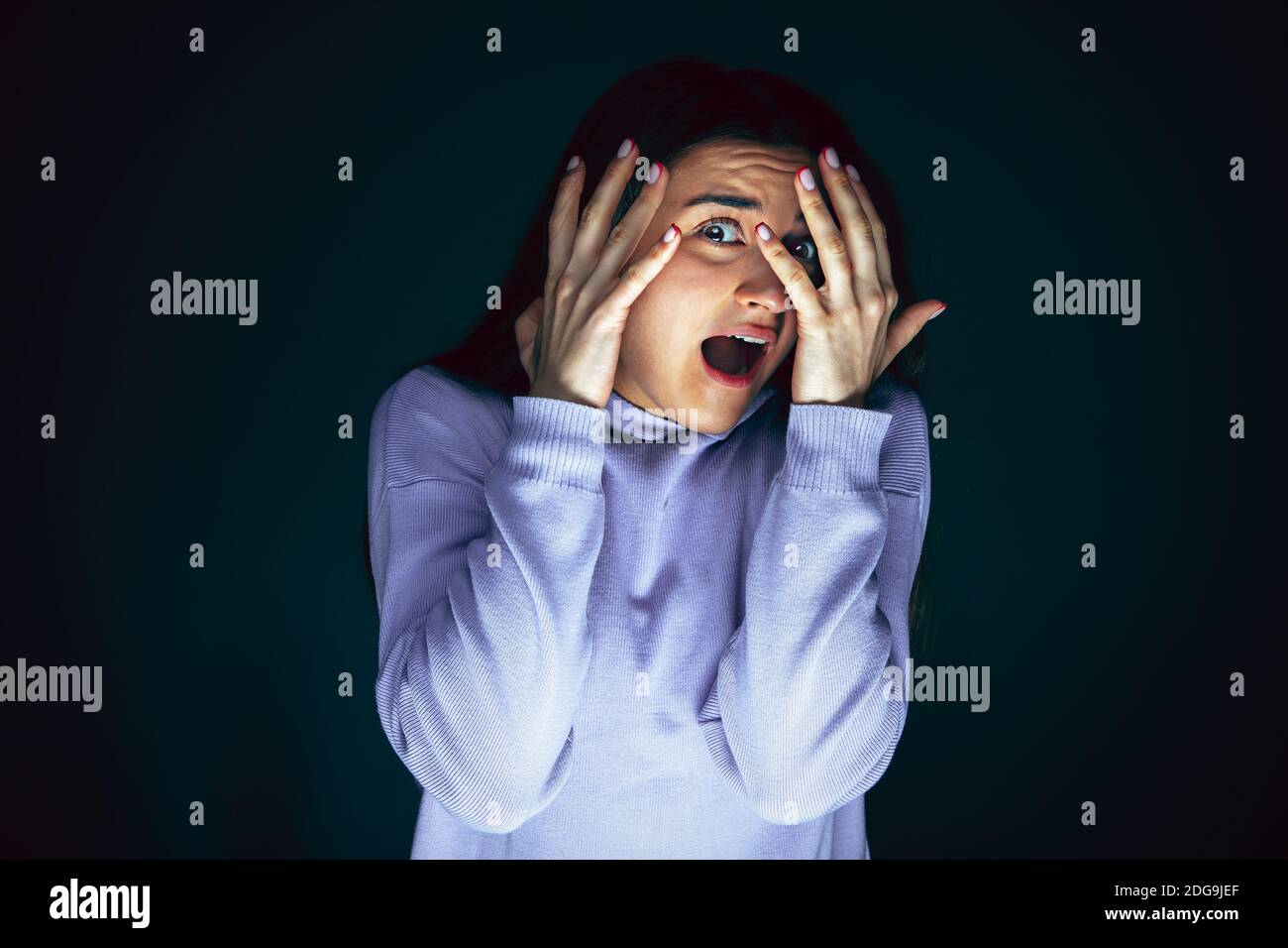Hiding. Portrait of young crazy scared and shocked caucasian woman ...