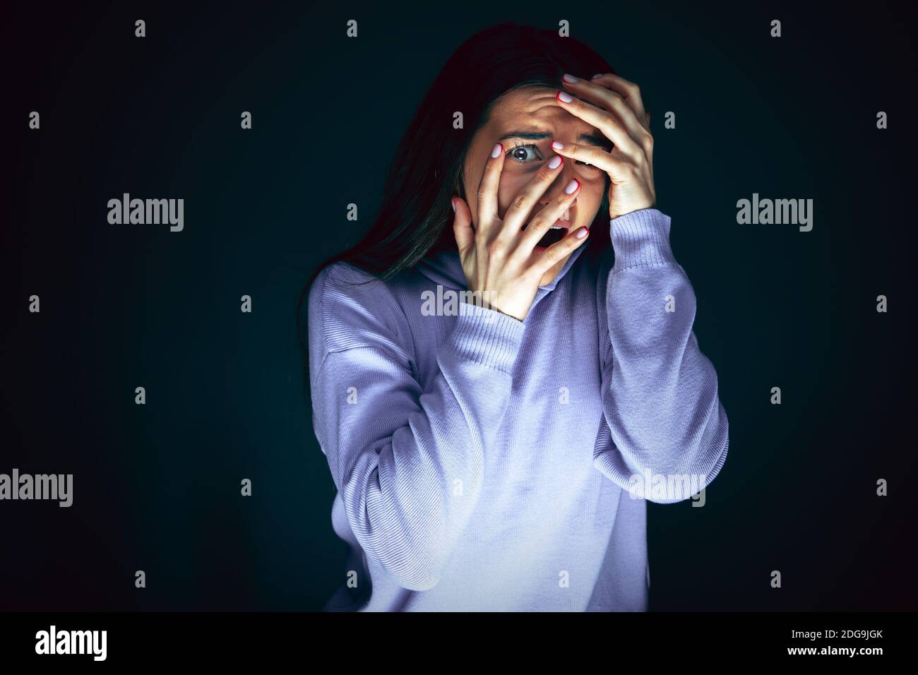 Hiding. Portrait of young crazy scared and shocked caucasian woman ...